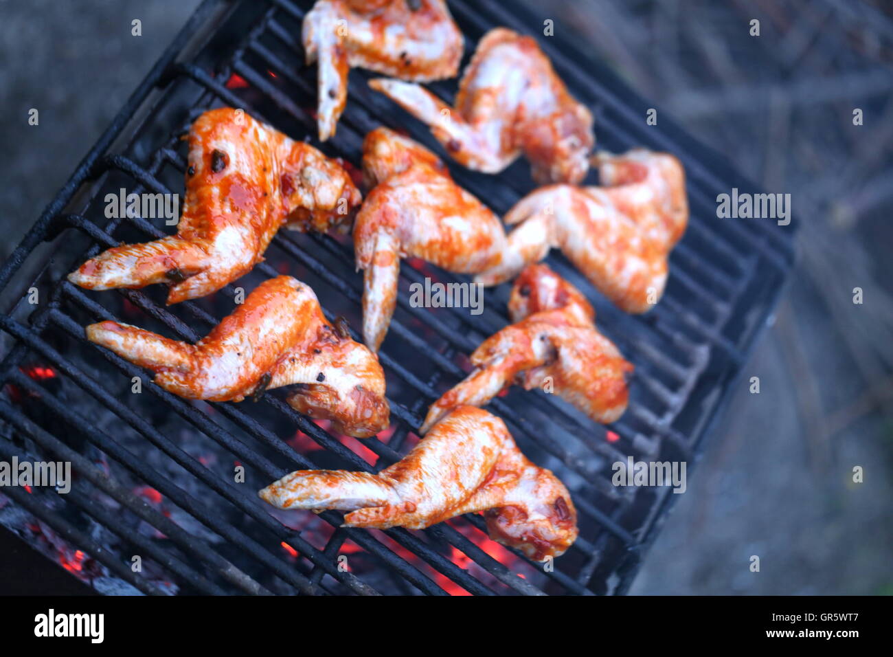 chicken wings being cooked on an outdoor barbeque Stock Photo - Alamy
