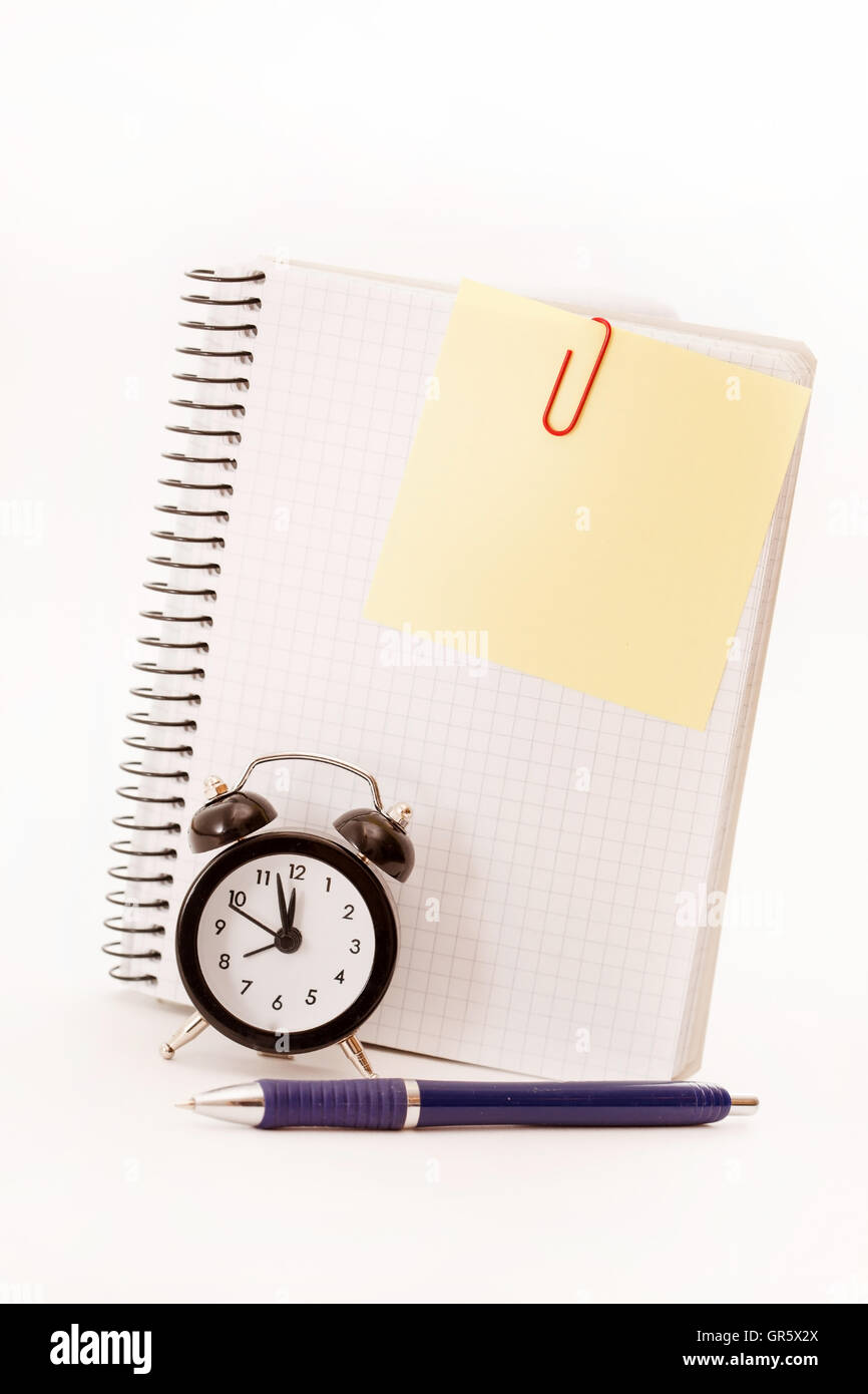 Alarm clock, blank notebook sheet on the white Stock Photo - Alamy