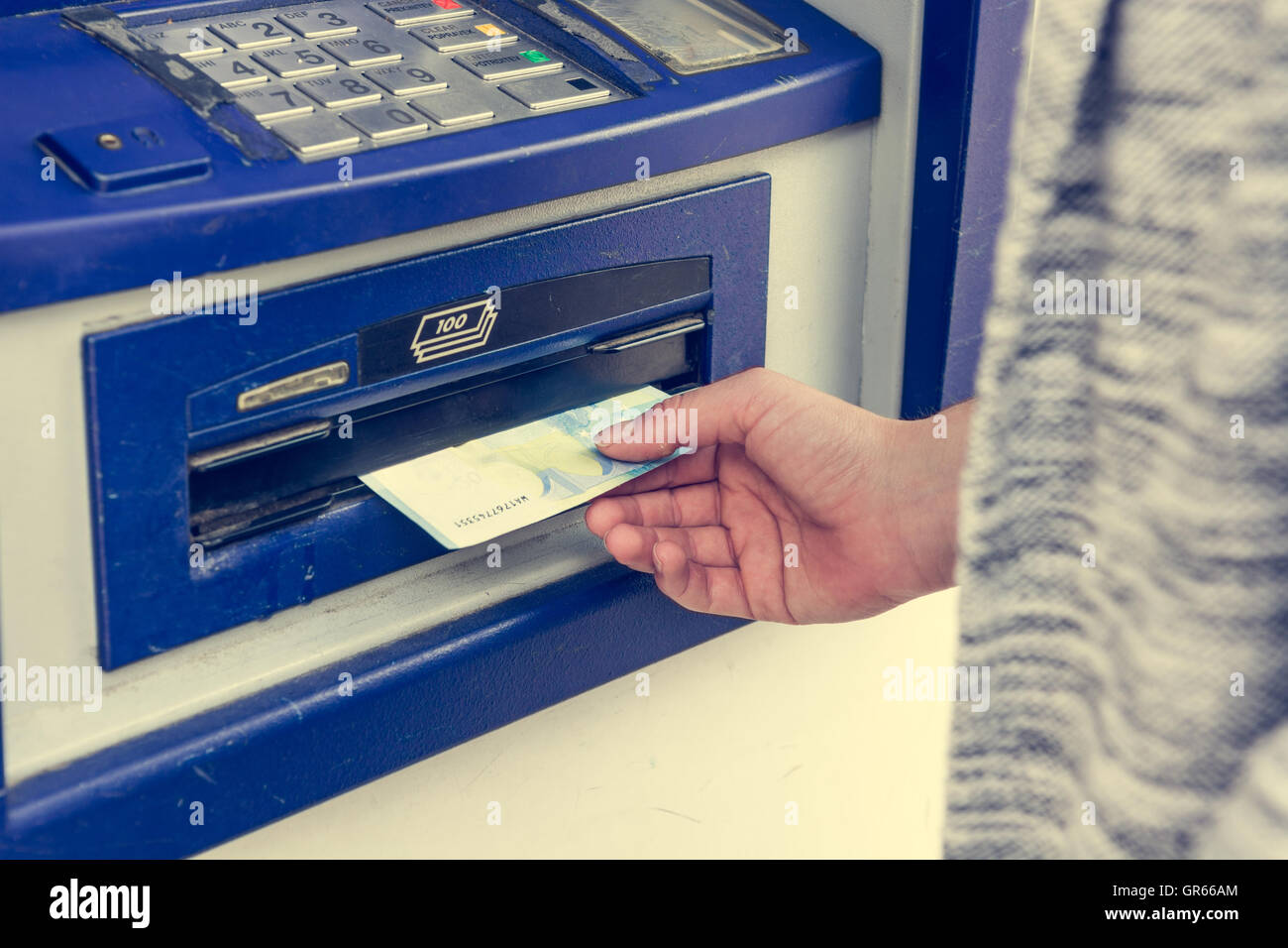 Closeup of receiving money from atm Stock Photo - Alamy
