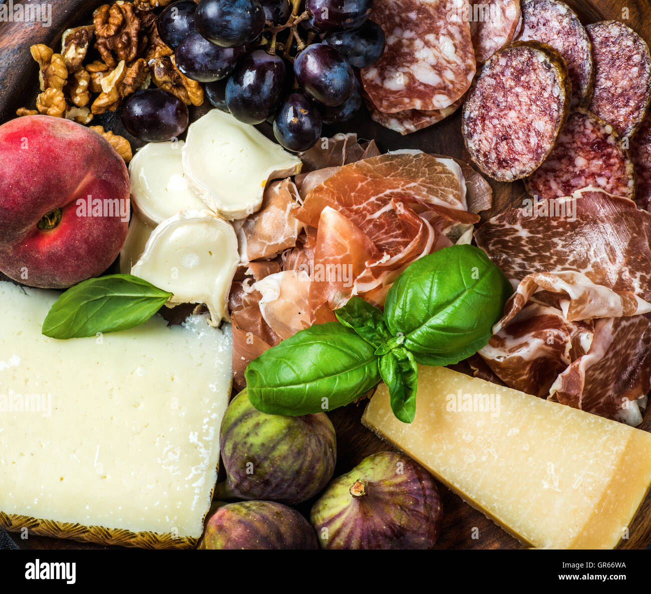 Italian snacks for wine variety over wooden tray background Stock Photo ...