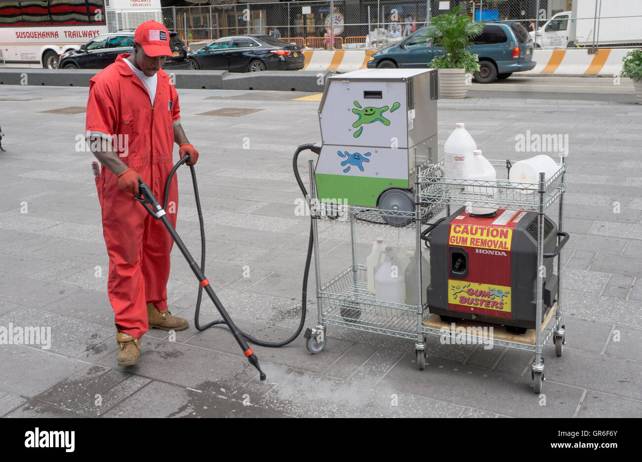 GUM BUSTER. A man cleans gum off the ground in Times Square in Midtown ...
