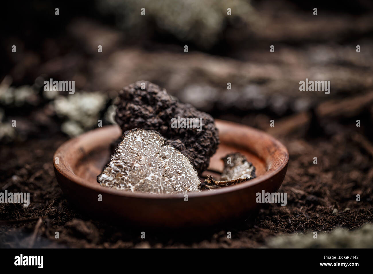 Black truffles slices in wooden plate Stock Photo - Alamy