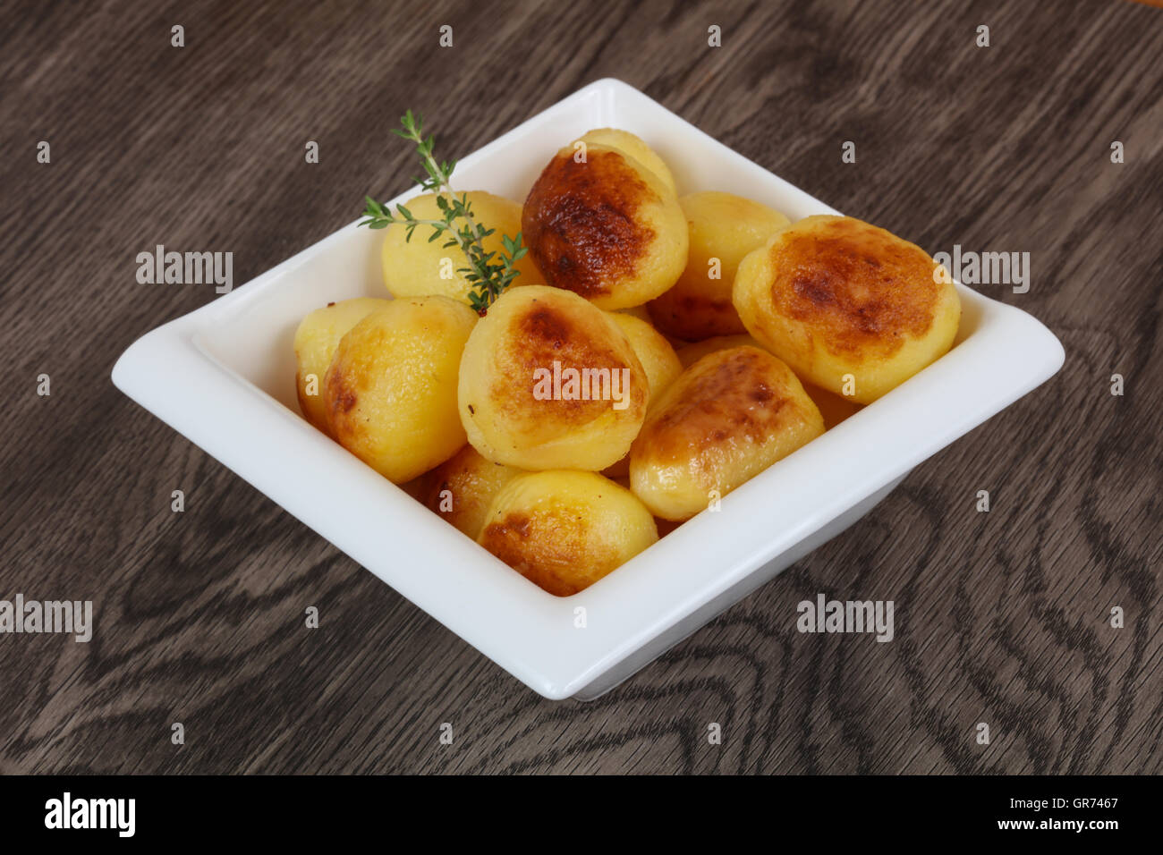 Golden backed potato with thyme branch Stock Photo - Alamy