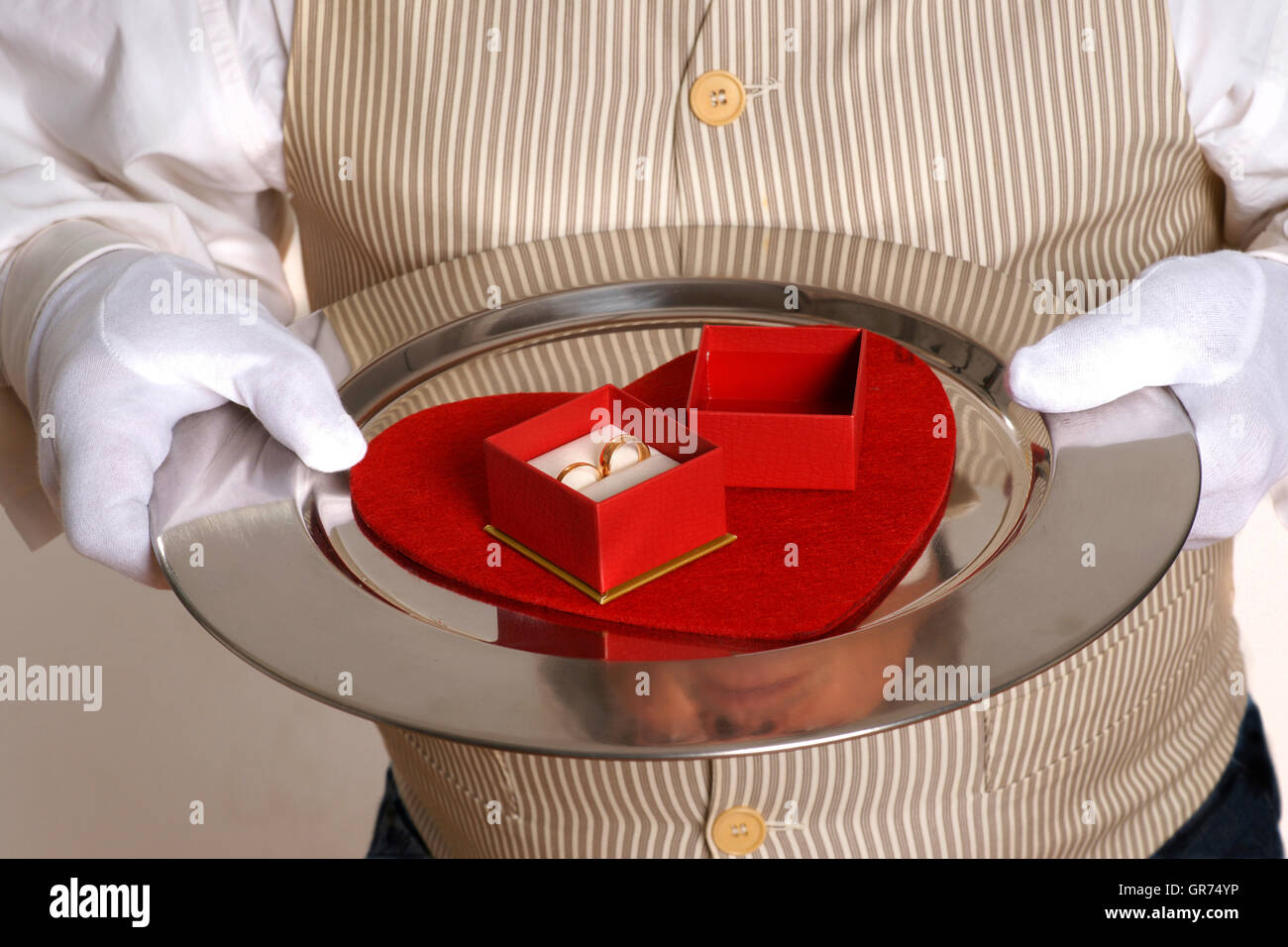Butler With A Heart With Wedding Rings Stock Photo - Alamy