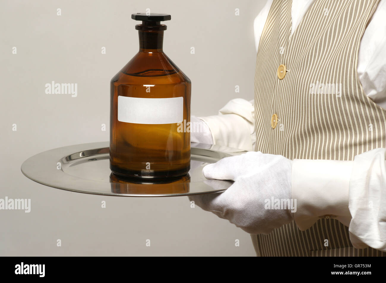 Butler With A Medizin-Bottle Stock Photo - Alamy