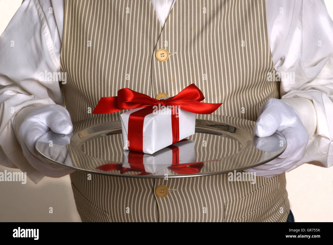 Butler With A Gift Stock Photo - Alamy