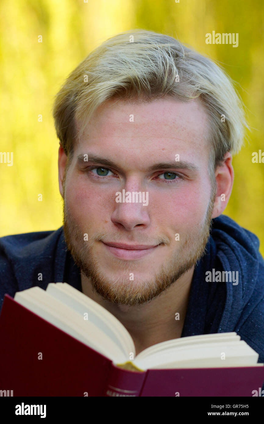 Young Man Reading A Book Stock Photo - Alamy