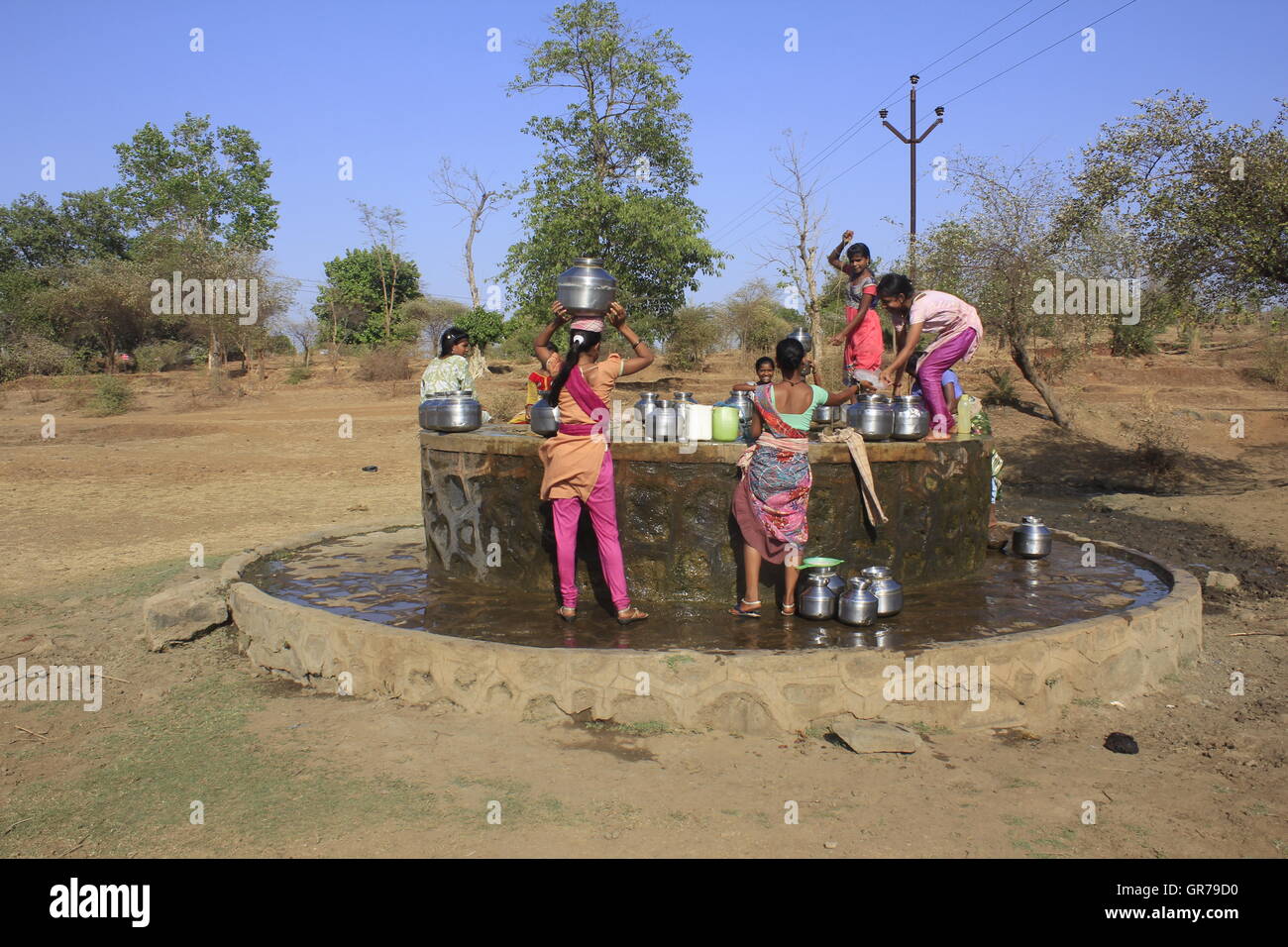women collecting water on well Stock Photo - Alamy