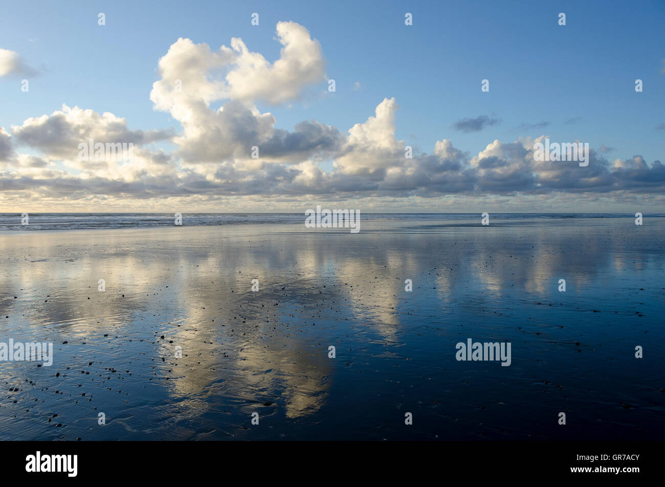 Clouds reflected in wet sand, Awakino Beach, Waikato, North Island, New ...