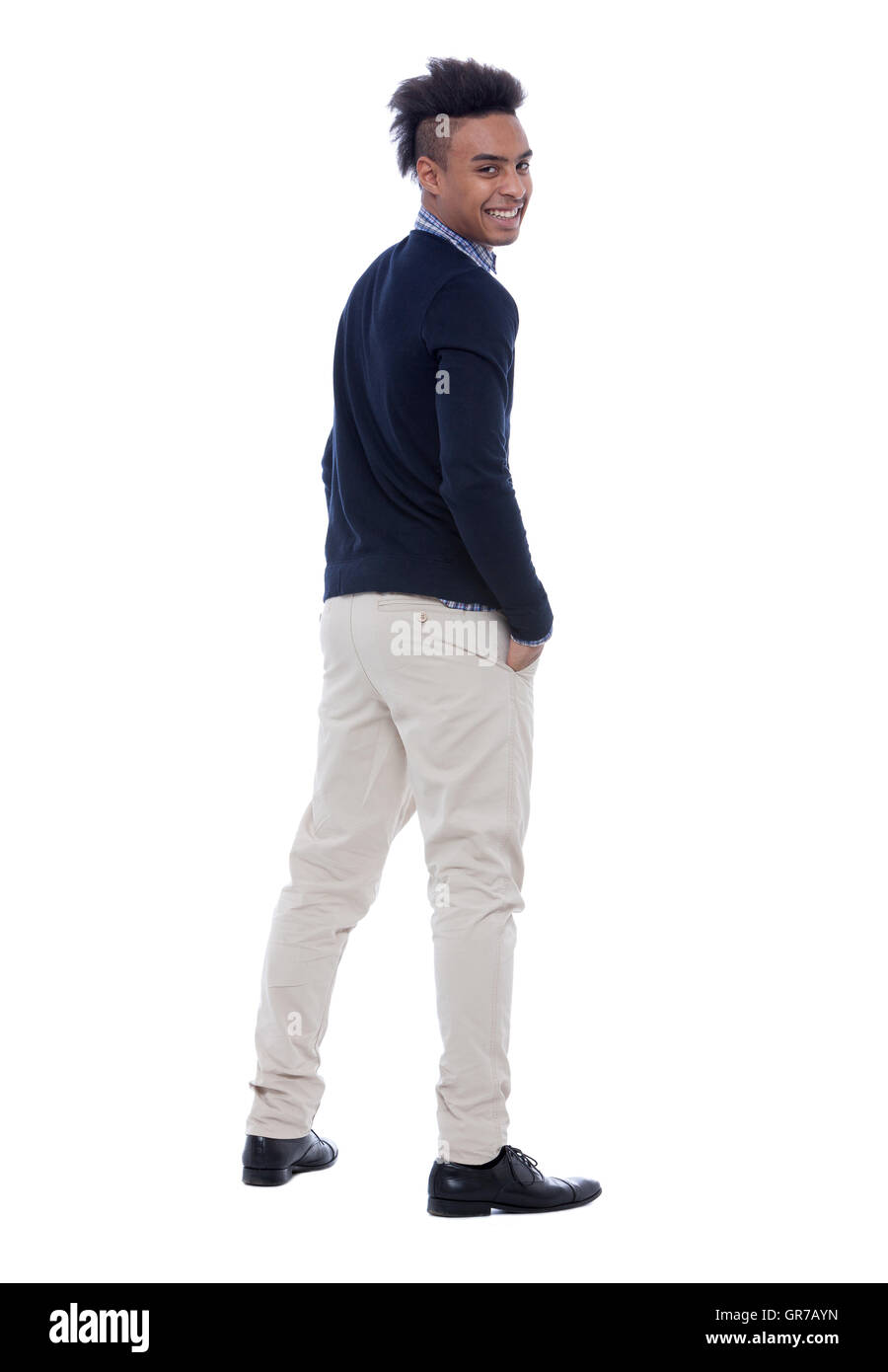 View from behind of a young african man standing relaxed with hands on ...