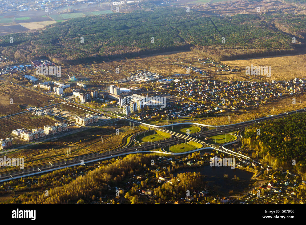 Road junction on a major highway, aerial view of landscape with forests ...