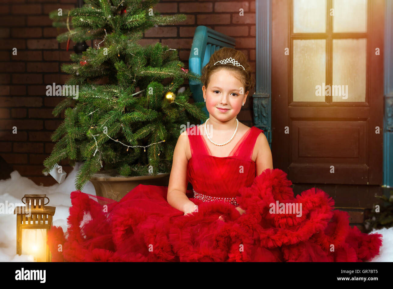 Little winter Princess in a precious crown in red dress welcomes New ...