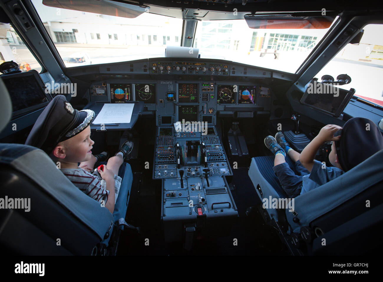 Young boys aged 5 and 2 visiting British Airways cockpit, whilst the ...