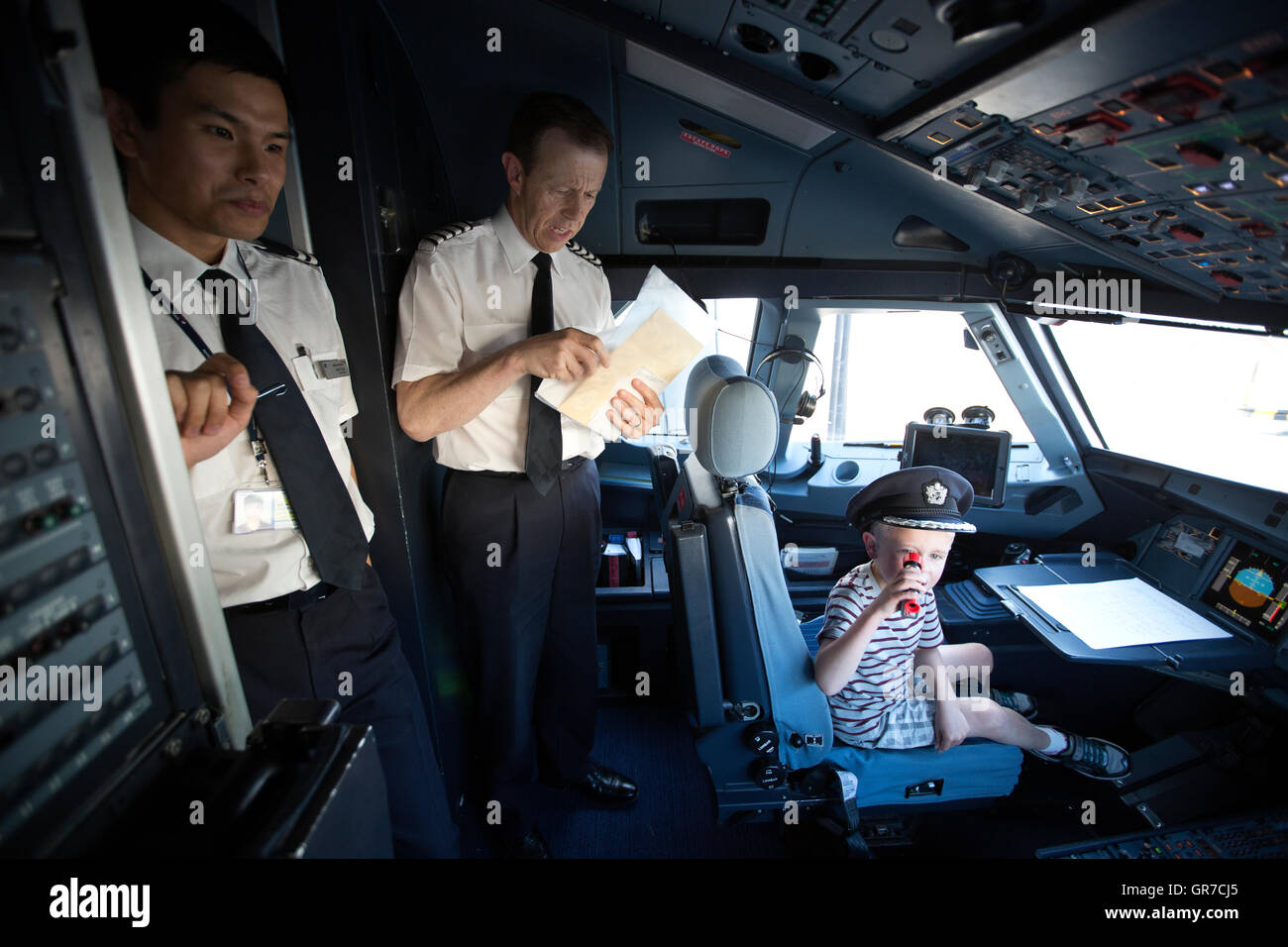 Young boys aged 5 and 2 visiting British Airways cockpit, whilst the ...
