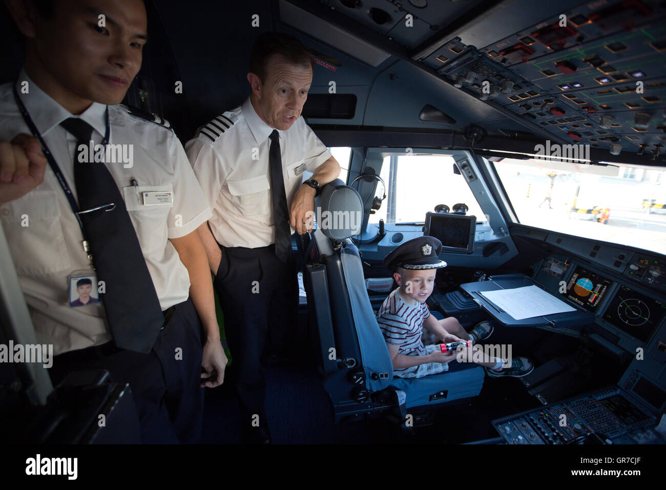 Young boys aged 5 and 2 visiting British Airways cockpit, whilst the ...