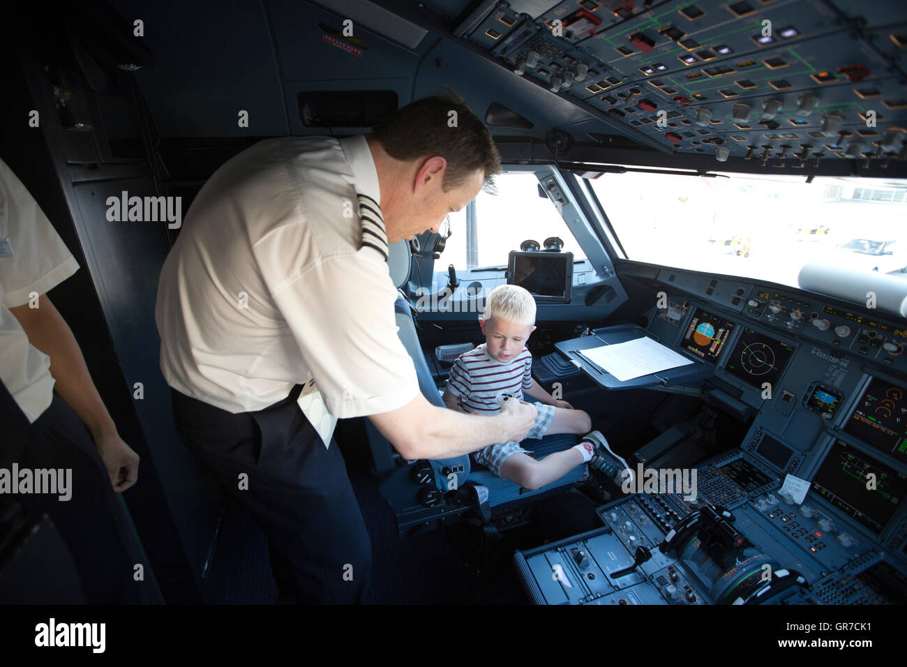 Young boys aged 5 and 2 visiting British Airways cockpit, whilst the ...