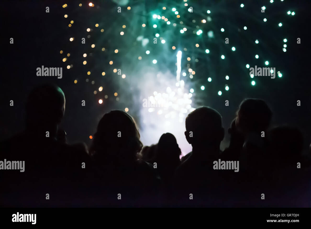 Happy people watching fireworks Stock Photo - Alamy