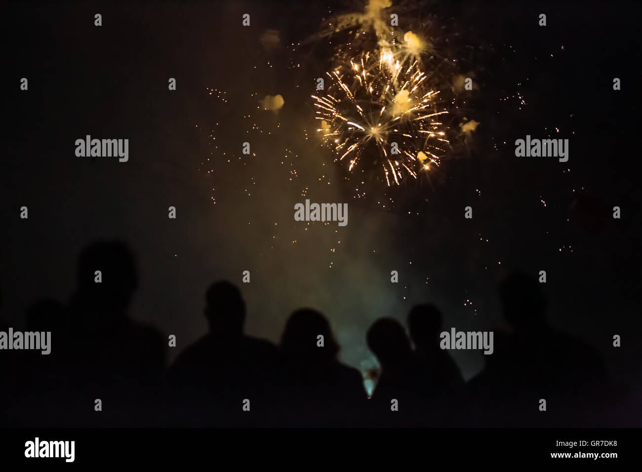Happy people watching fireworks Stock Photo - Alamy