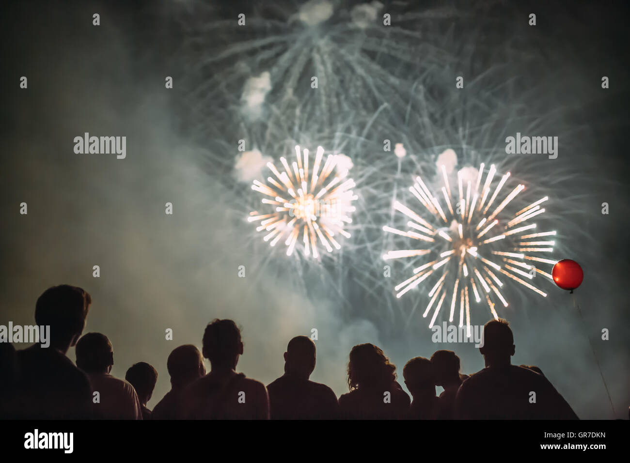 Happy people watching fireworks Stock Photo - Alamy