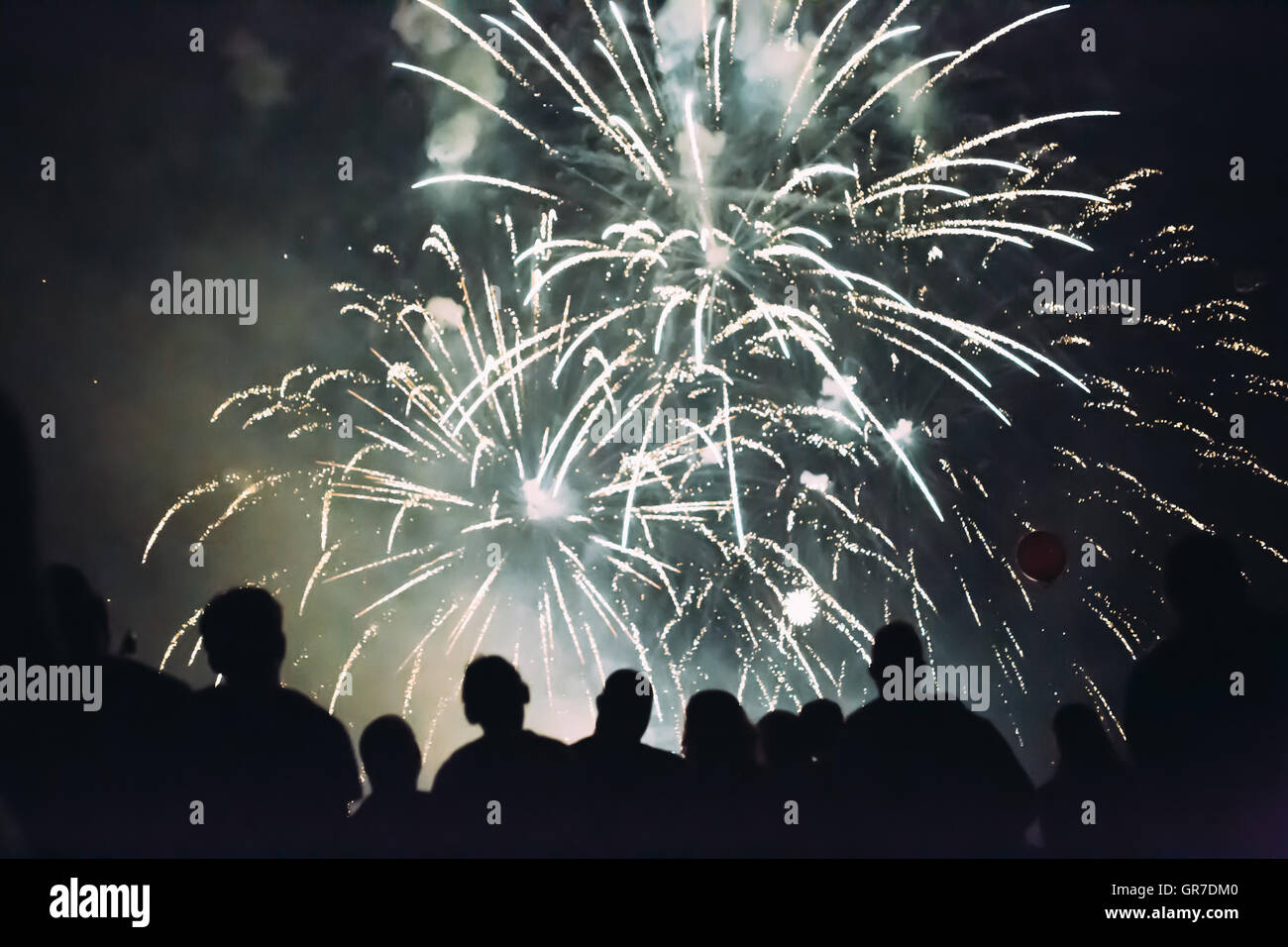 Happy people watching fireworks Stock Photo - Alamy