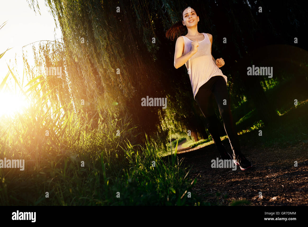 Beautiful woman running in nature Stock Photo - Alamy