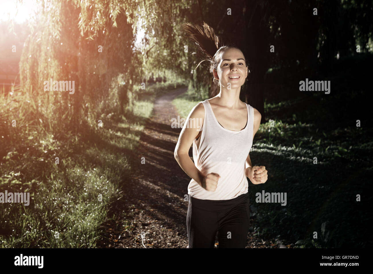 Beautiful woman running in nature Stock Photo - Alamy