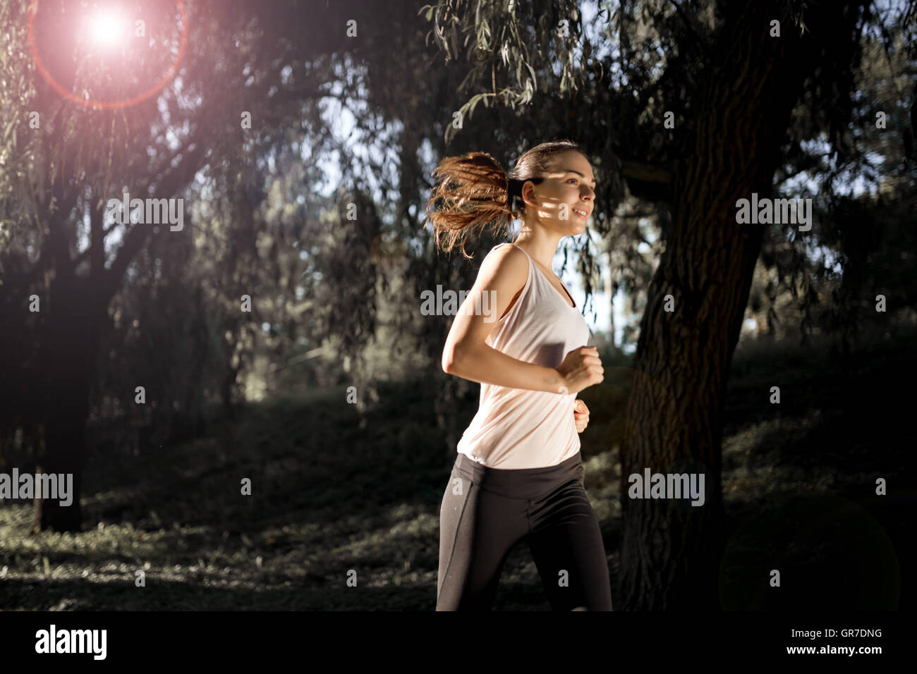 Beautiful woman running in nature Stock Photo - Alamy