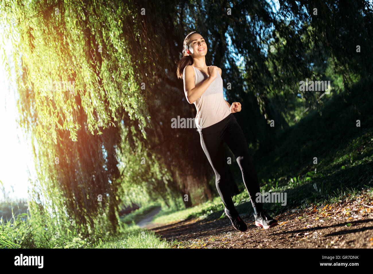 Beautiful woman running in nature Stock Photo - Alamy