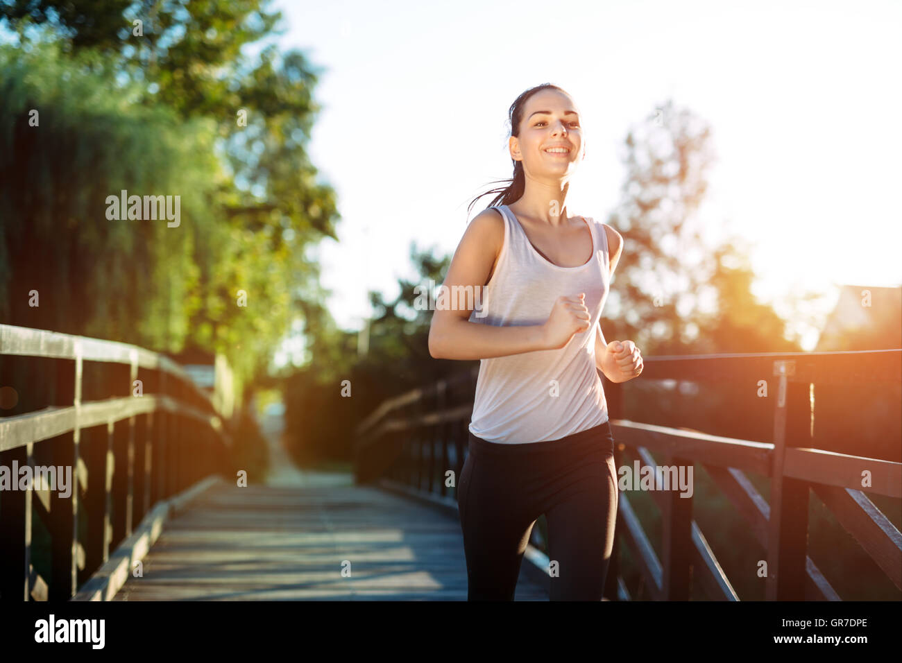 Athletic woman jogging in nature during summer Stock Photo - Alamy