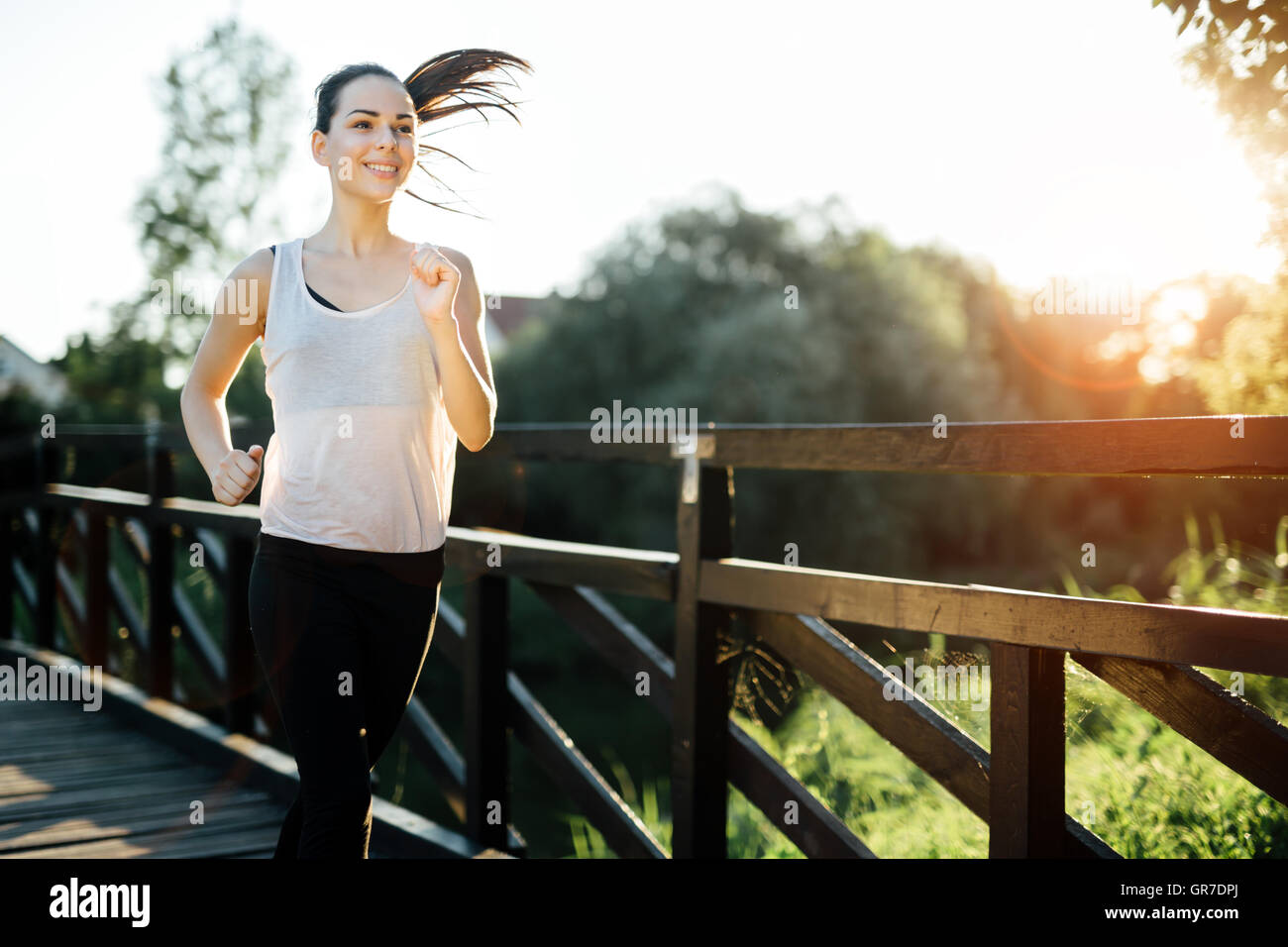 Beautiful woman running in nature Stock Photo - Alamy
