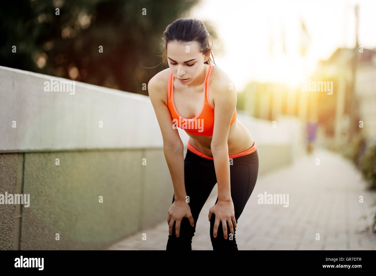 Fatigue of female runner Stock Photo - Alamy