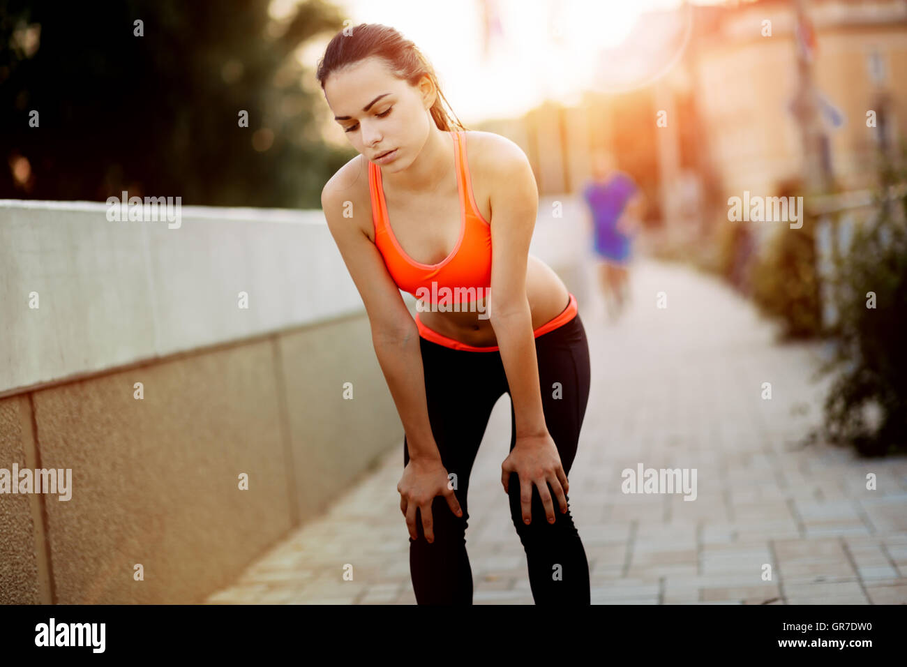 Fatigue of female runner Stock Photo - Alamy