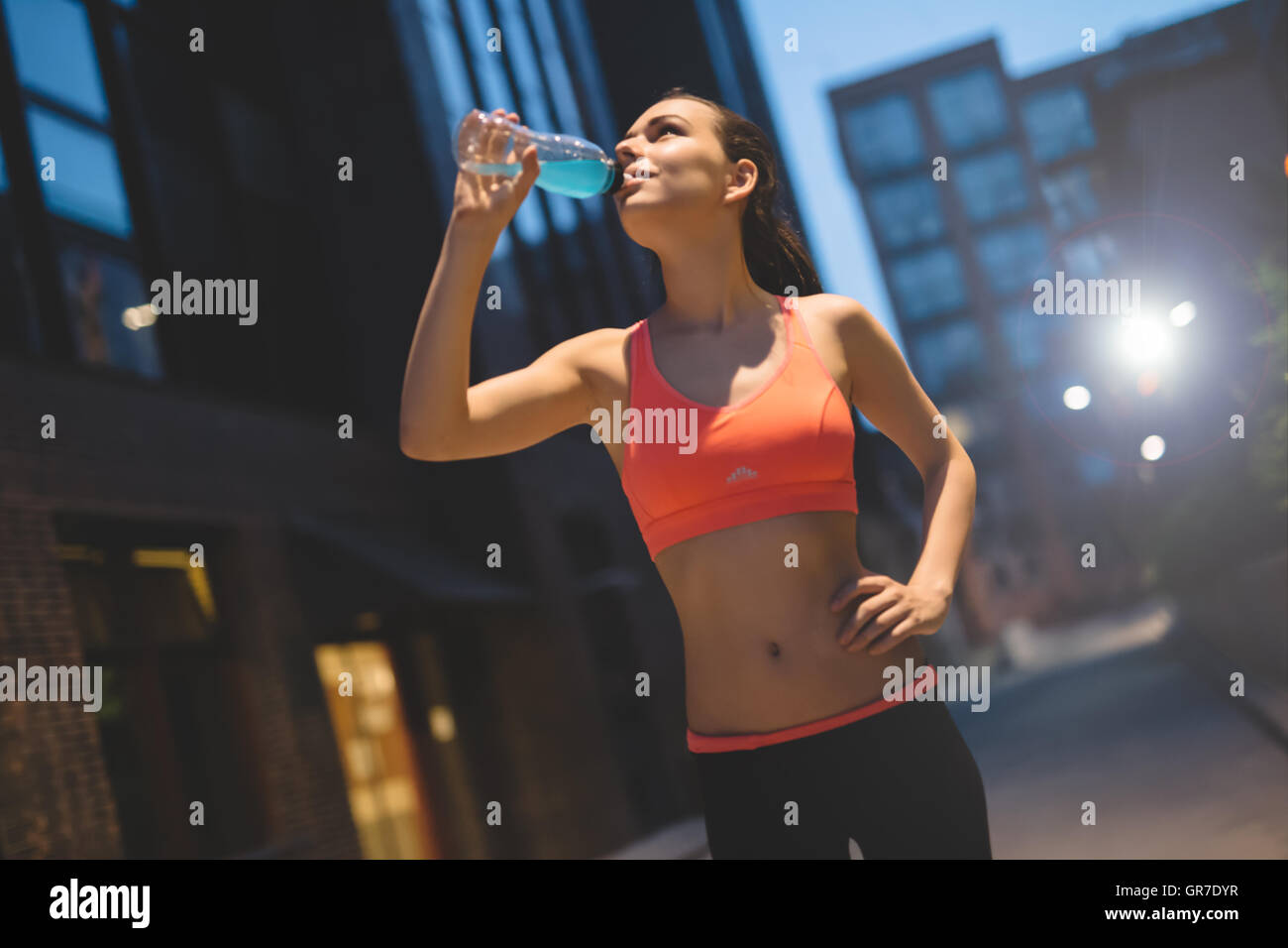 Thirsty sportswoman drinking water after workout Stock Photo - Alamy