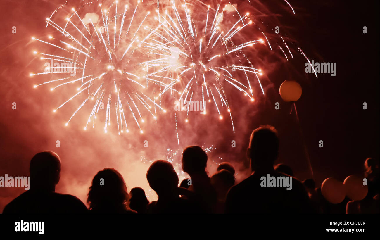 Happy people watching fireworks Stock Photo - Alamy