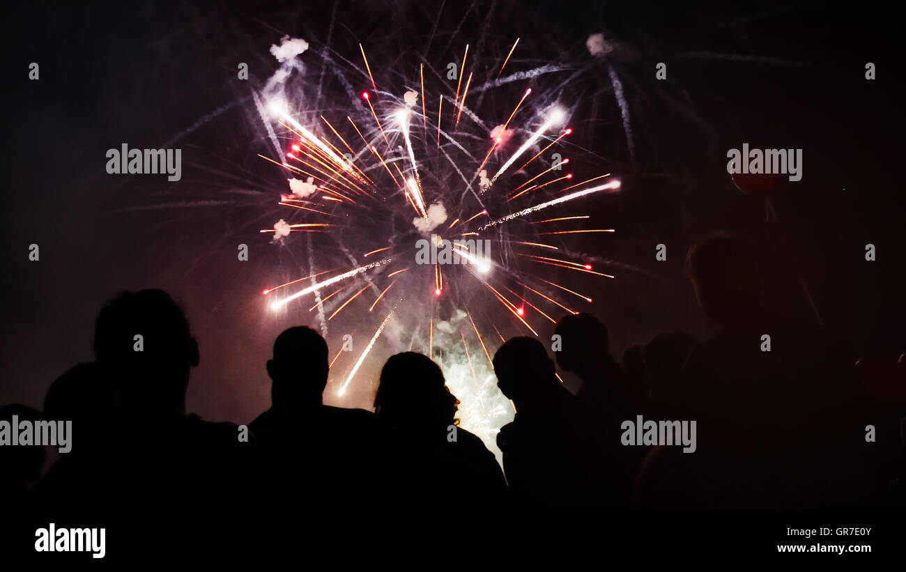 Happy people watching fireworks Stock Photo - Alamy