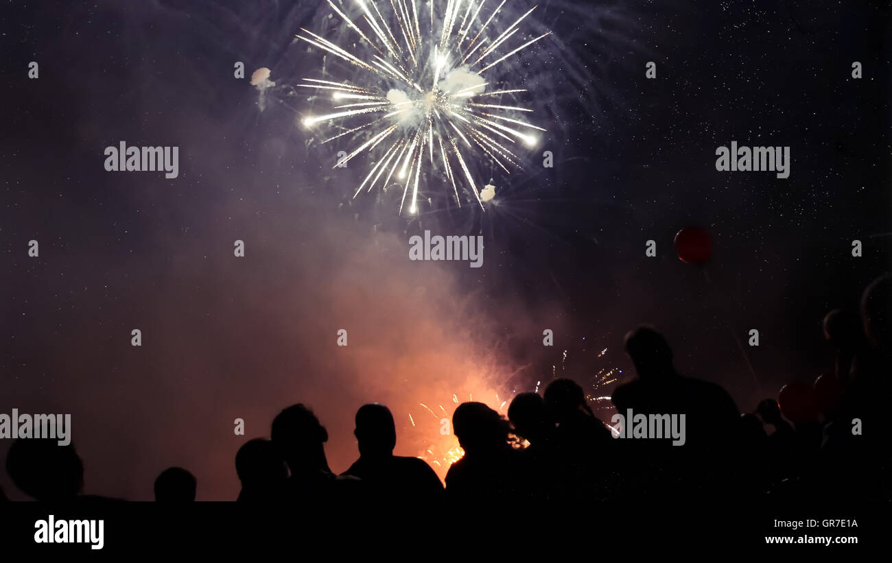 Crowd watching fireworks and celebrating Stock Photo - Alamy