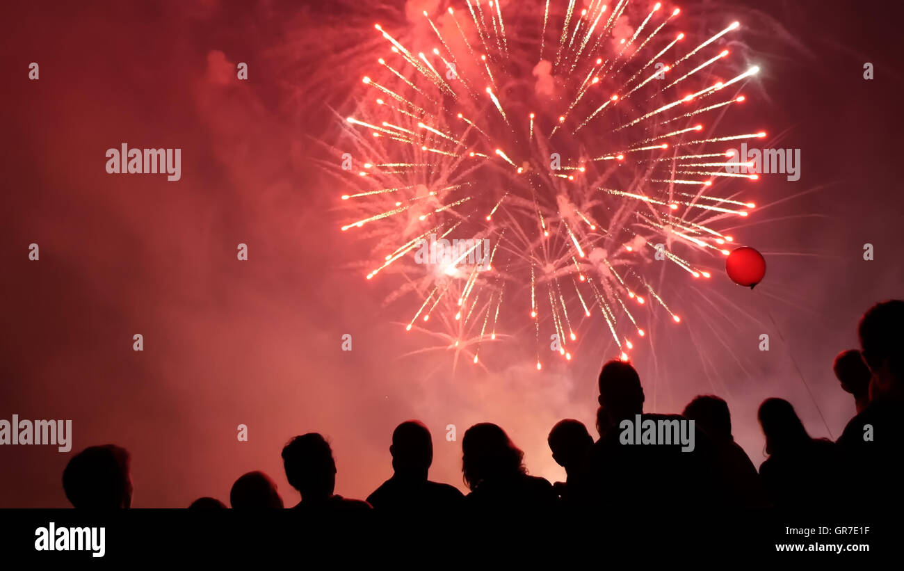 Happy people watching fireworks Stock Photo - Alamy