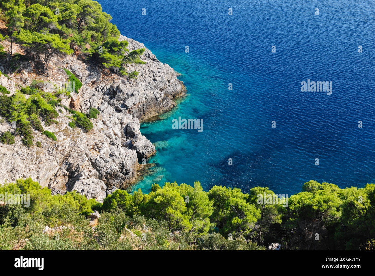 Nature background, sea, rocks and green forest Stock Photo - Alamy