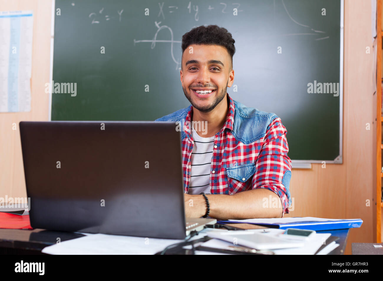 Hispanic Man Using Laptop Computer, Student In University Classroom At ...