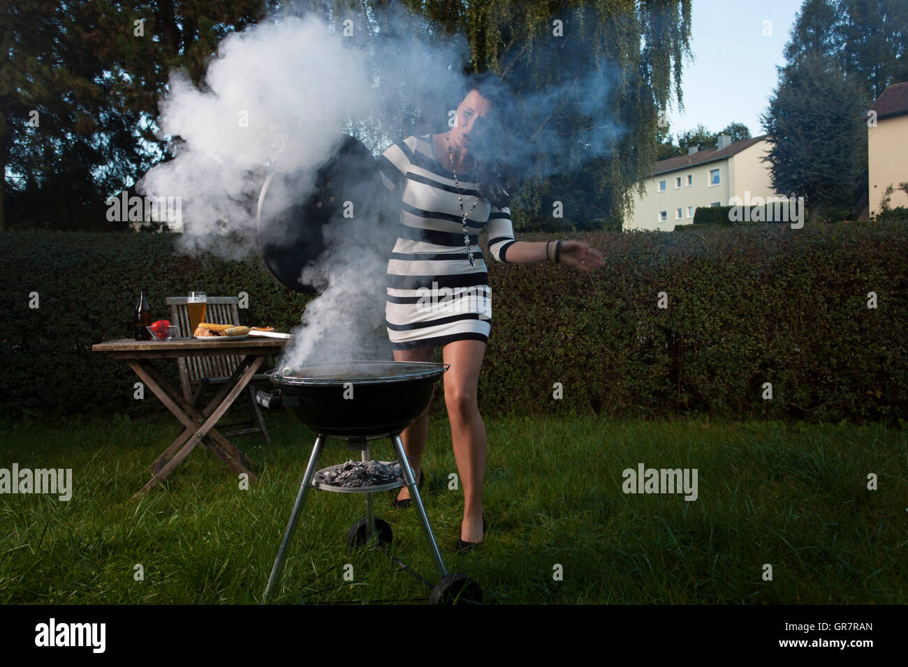 Woman grilling corn hi-res stock photography and images - Alamy