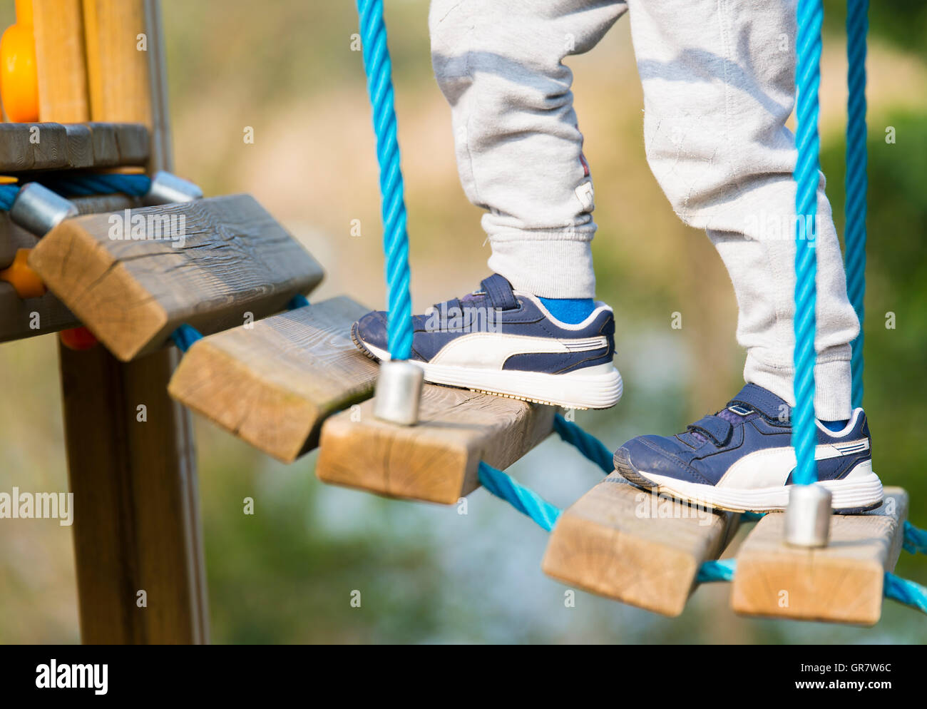 Child crossing rope bridge hi-res stock photography and images - Alamy