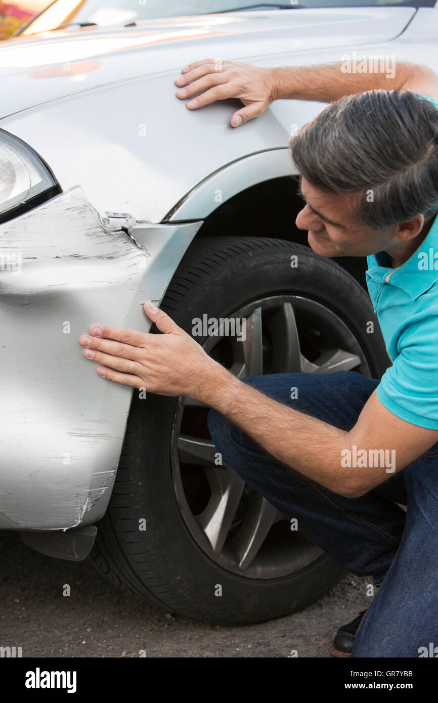 Unhappy Driver Inspecting Damage After Car Accident Stock Photo - Alamy
