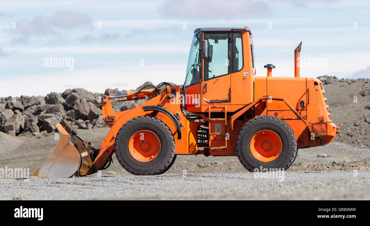 Large orange bulldozer on a building site Stock Photo - Alamy