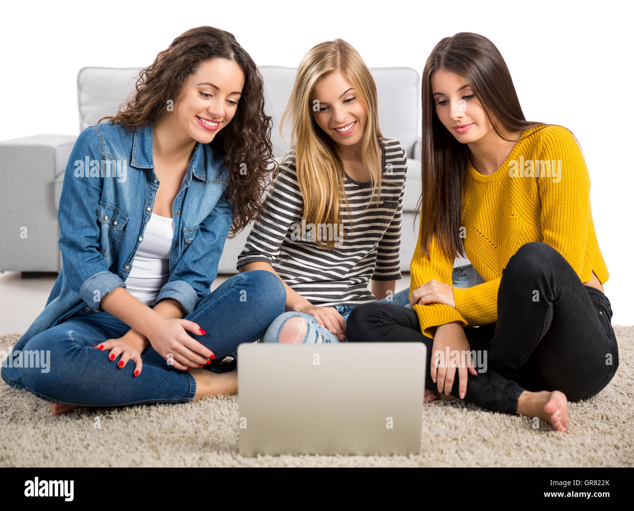 Happy teen girls studying at home with a laptop Stock Photo - Alamy