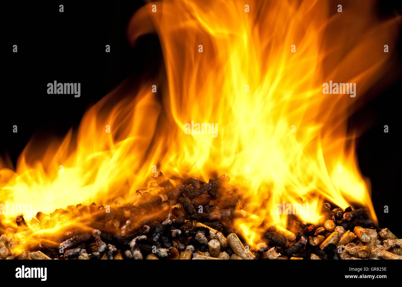 burning wood pellet with flame Stock Photo - Alamy