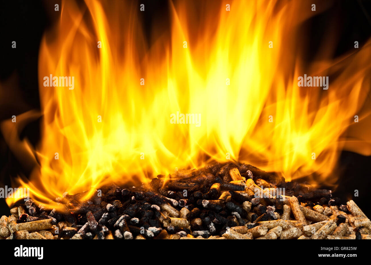 burning wood pellet with flame Stock Photo - Alamy