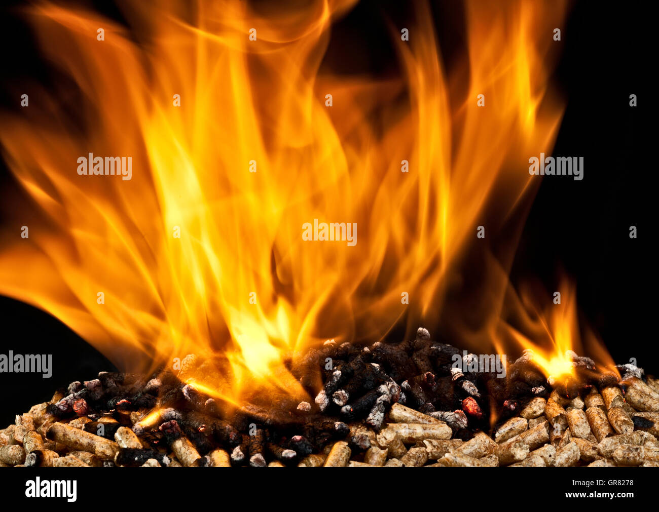 burning wood pellet with flame Stock Photo - Alamy