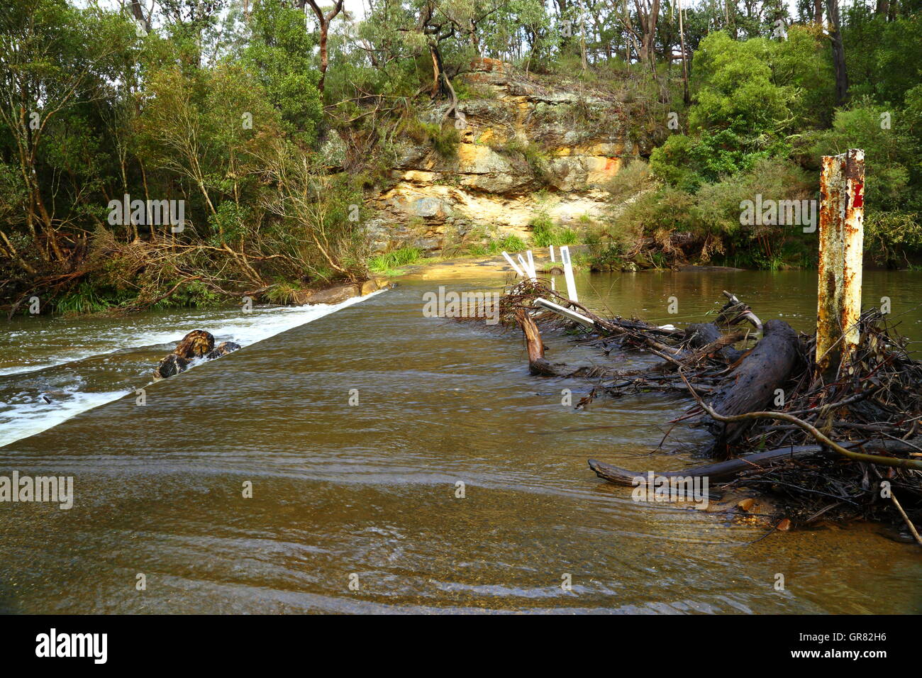 Flooded road crossing over a creek crossing at Belmore Falls near ...