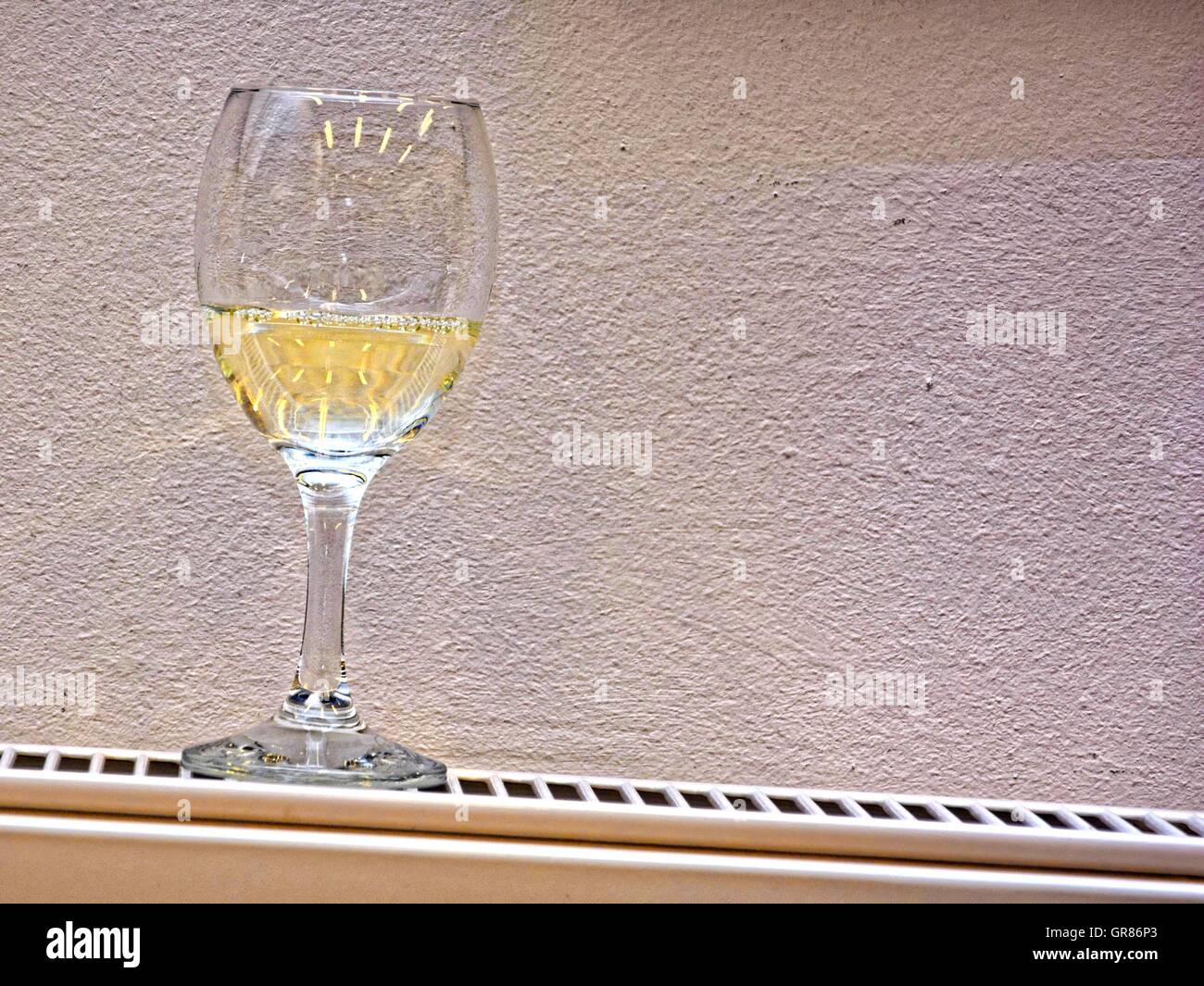 Wineglass With White Wine On Sloping Radiator, Radiator Stock Photo - Alamy
