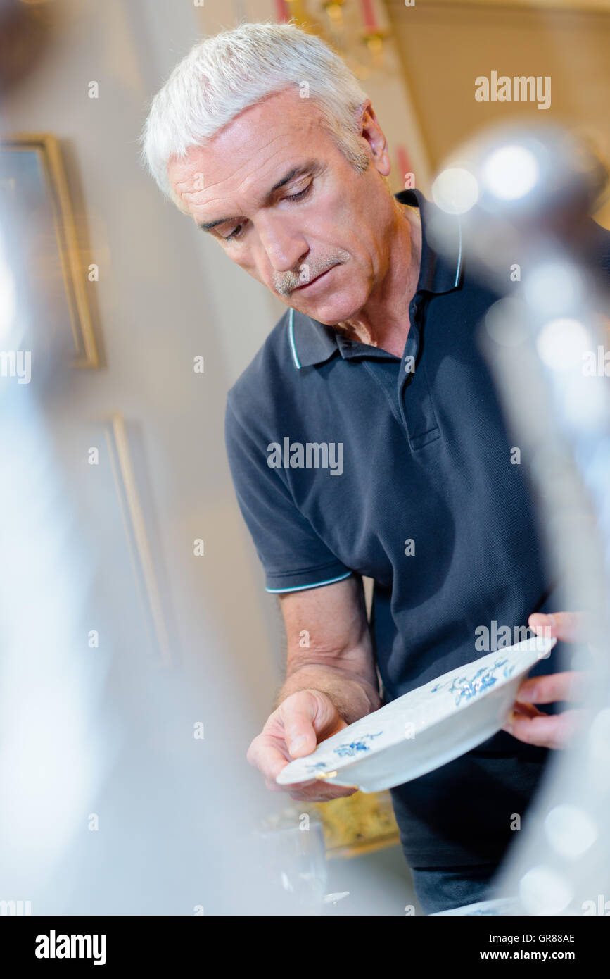 man looking at plate Stock Photo - Alamy